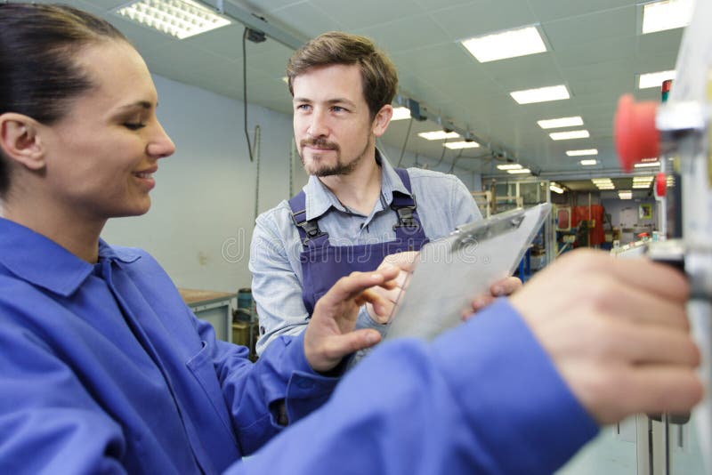 Woman Adjusting Settings on Industrial Machinery Stock Photo - Image of ...