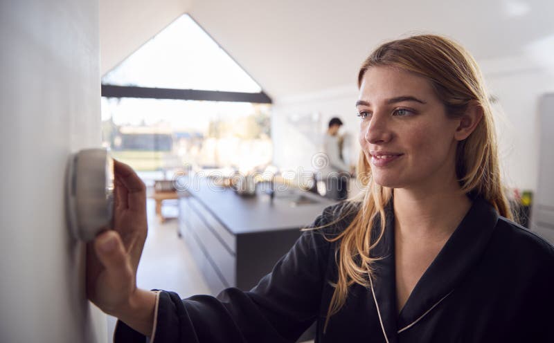 Woman Adjusting Wall Mounted Digital Central Heating Thermostat Control ...