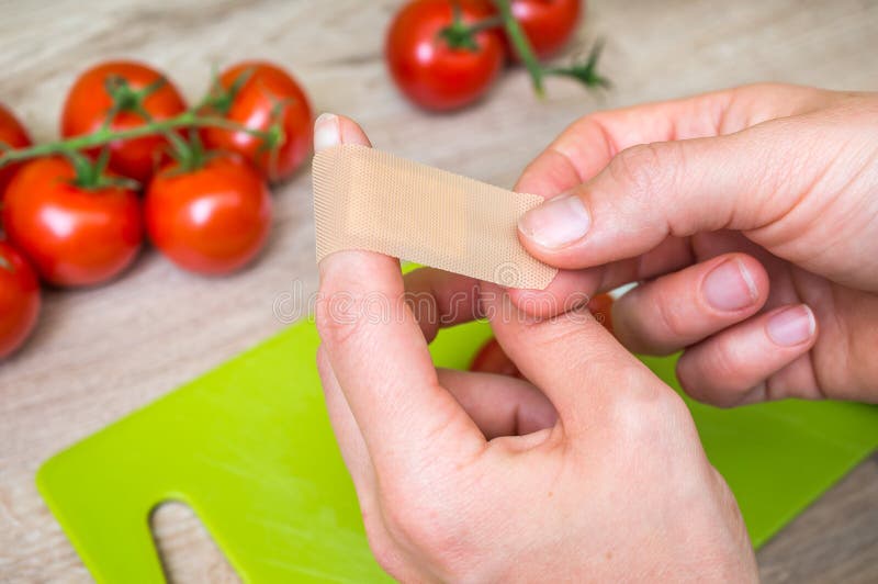 Woman Apply Plaster on Her Finger - Injury in Kitchen Stock Image ...