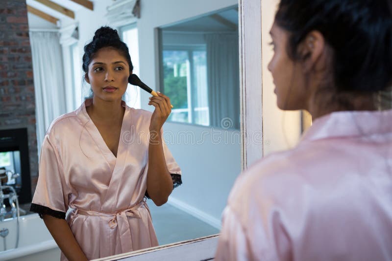 Woman Applying Blush with Reflection on Mirror Stock Photo - Image of ...