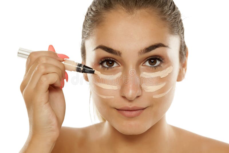 Woman applying concealer stock photo. Image of skincare - 105402014