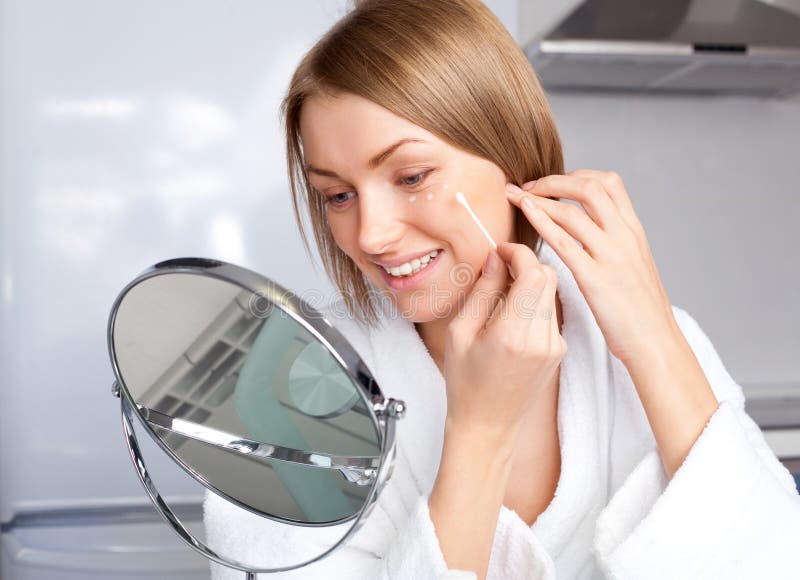 Woman applying cream stock image. Image of cotton, house - 16903617