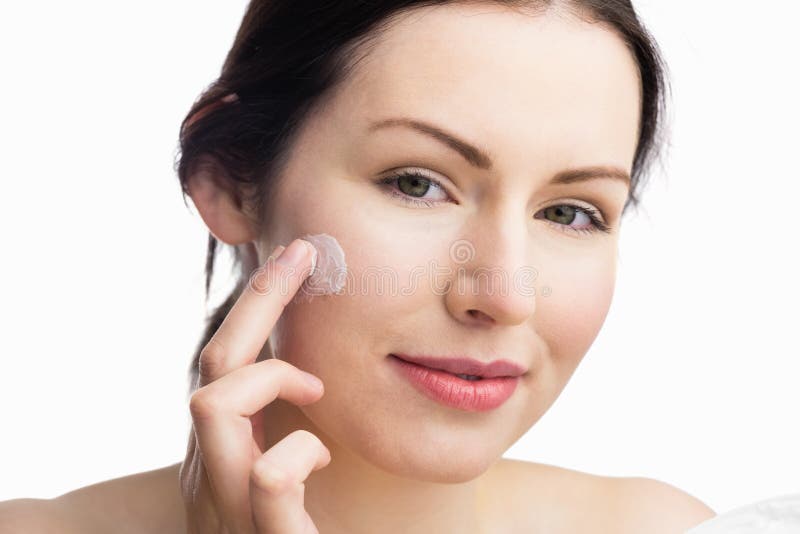 Woman applying a cream stock image. Image of putting - 77690129