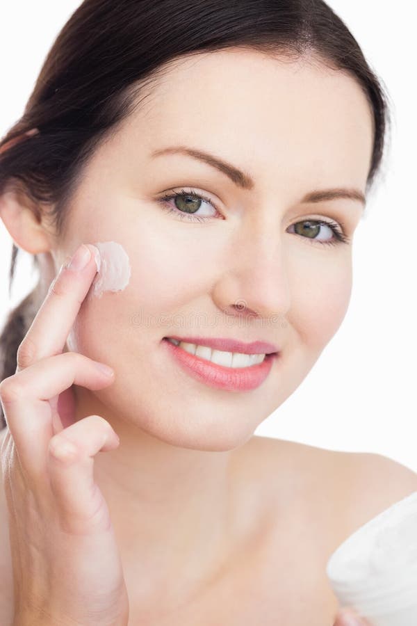Woman applying a cream stock photo. Image of face, fresh - 77690144