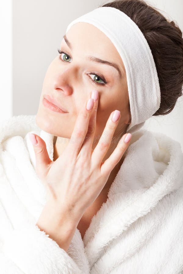 Woman applying eye cream stock image. Image of caucasian - 12128583