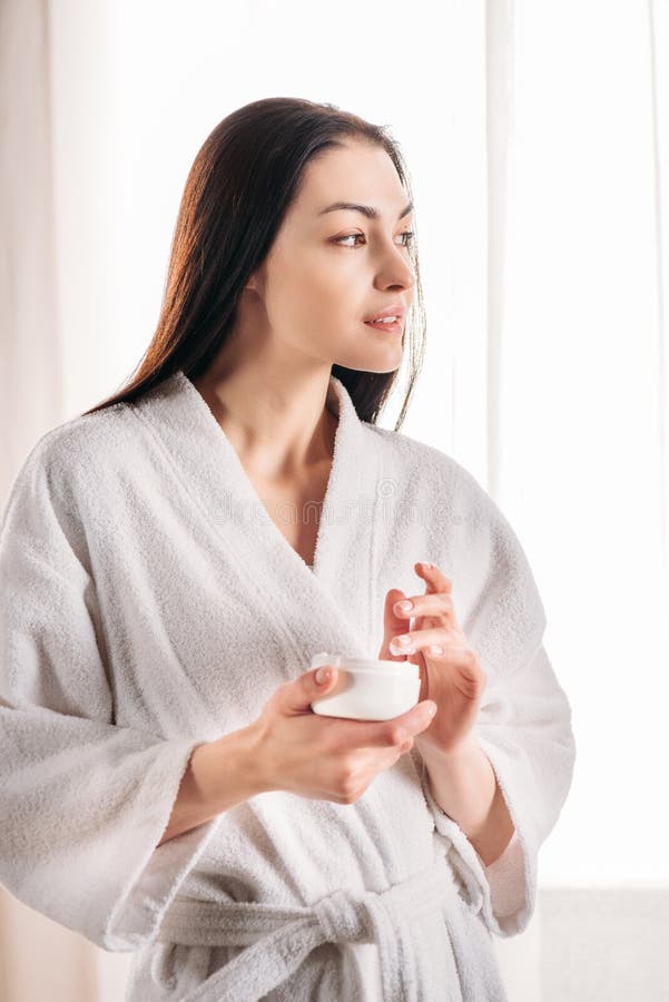 Woman applying face cream stock image. Image of alone - 109812787
