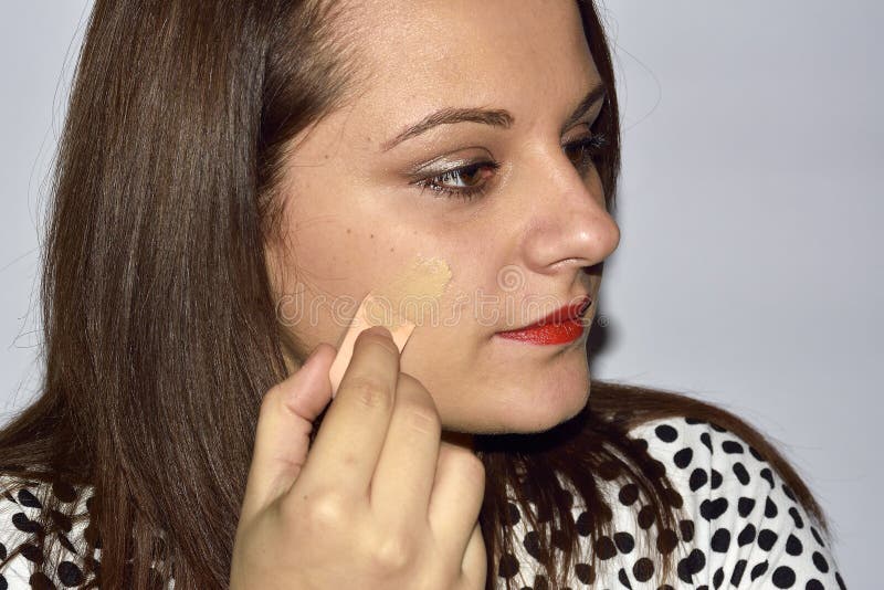 The Woman Applying Foundation on Face with Sponge Stock Image - Image ...