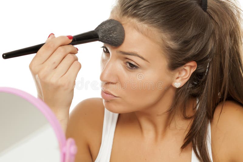 Woman applying foundation stock image. Image of model - 107919079