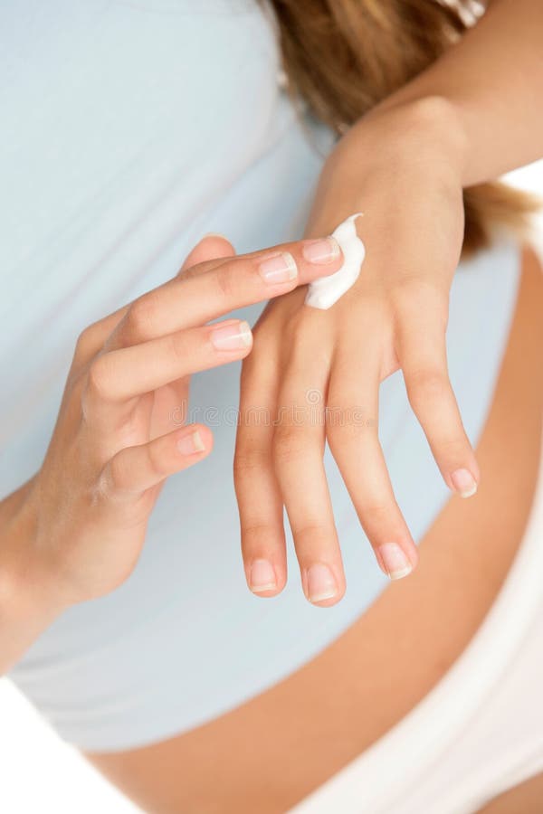 Woman applying hand cream stock photo. Image of light - 10706718