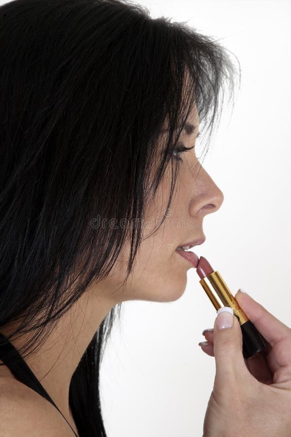 Woman applying lipstick stock photo. Image of applying - 17585900