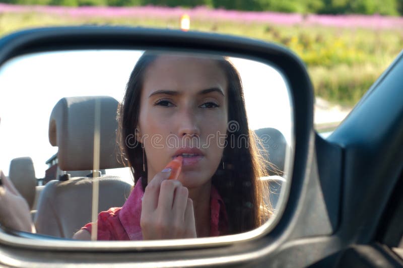 Woman Applying Lipstick Looking at Car Mirror Stock Photo - Image of ...