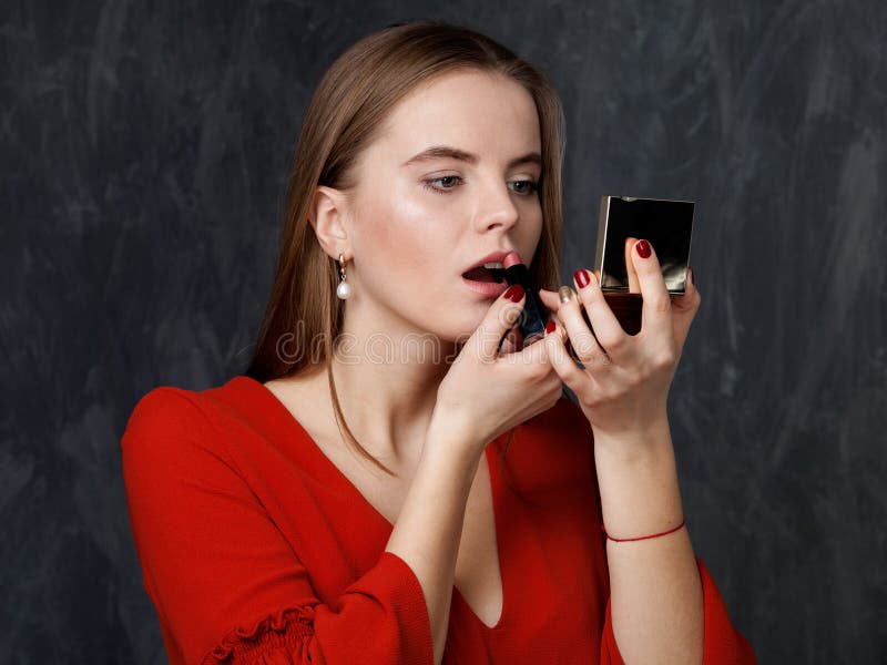 Woman Applying Lipstick Looking In To The Mirror Stock Image Image Of