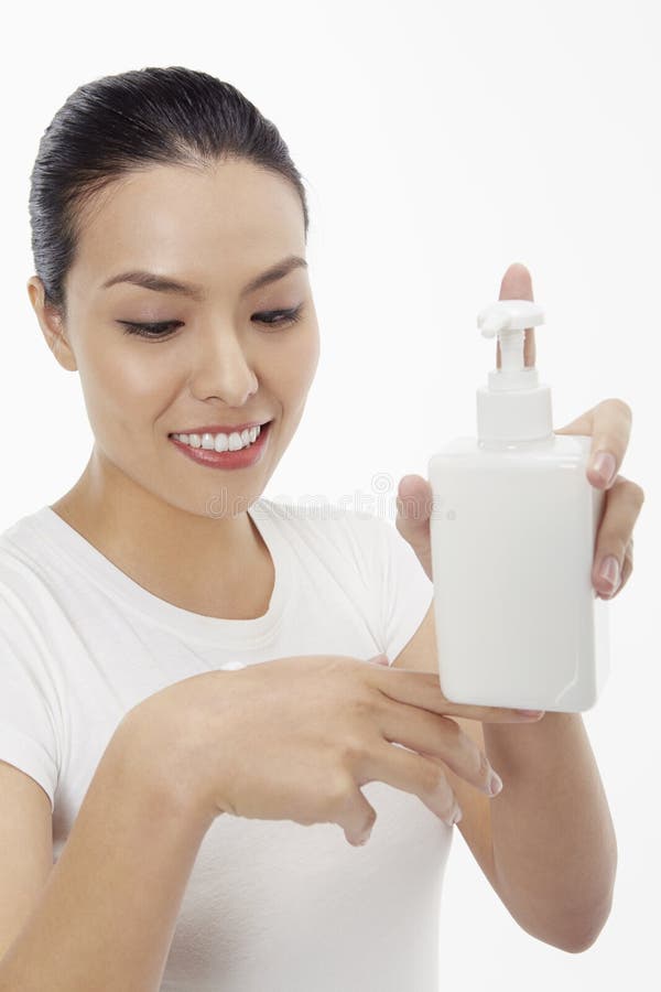 Woman Applying Lotion on Her Hand Stock Image - Image of shot, cheerful ...