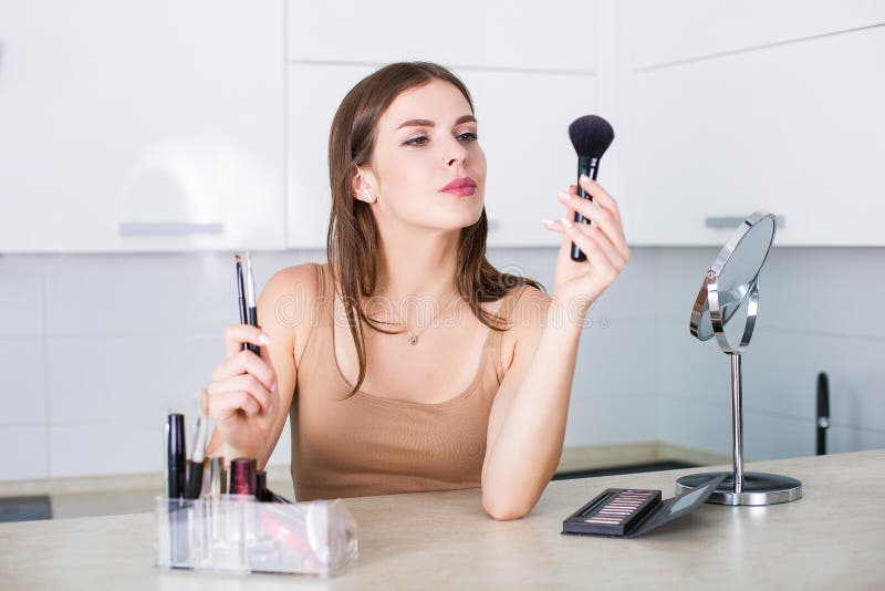 Woman applying makeup stock photo. Image of artist, beauty - 96672656