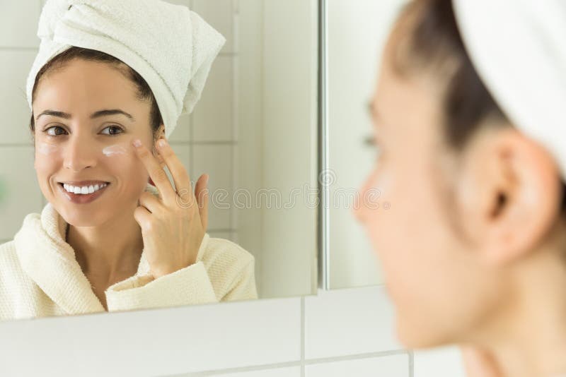 Woman Applying Moisturizer To Her Face Stock Image - Image of cosmetics ...