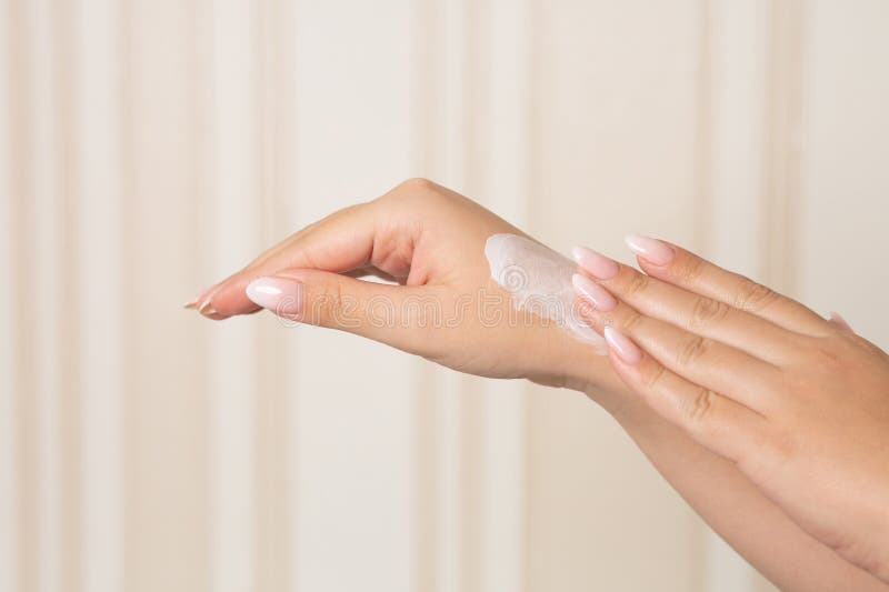 Woman Applying Moisturizing Lotion on Her Hands Stock Photo - Image of ...