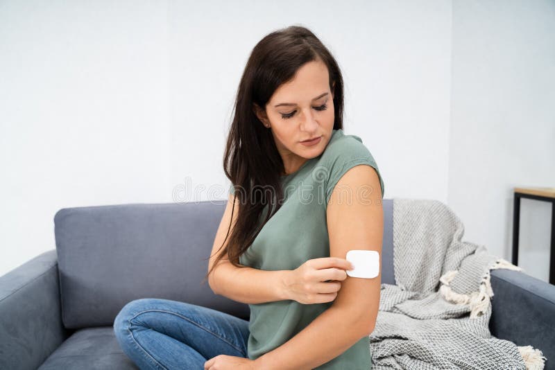 Woman Applying Patch on Her Arm Stock Photo - Image of estrogen ...