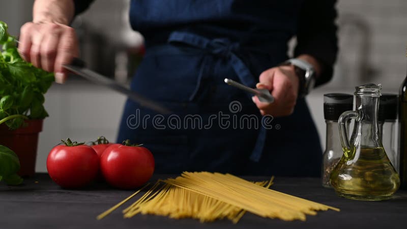 Woman in Apron Sharpening a Knife in Kitchen Stock Video - Video of ...