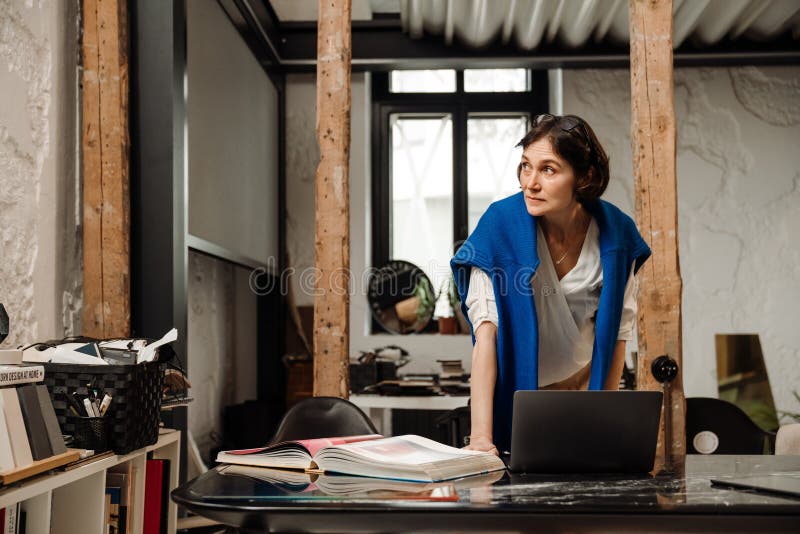 Woman Architect Examining Catalog during Work on Interior Design ...