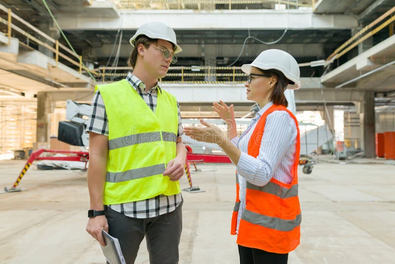 Woman Architect and Man Builder at a Construction Site. Building ...
