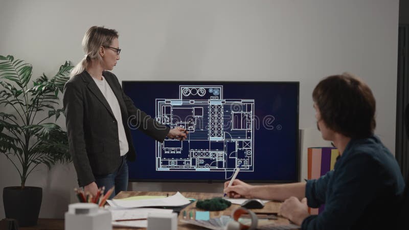 A Woman Architect is Presenting a Project in a Design Studio Office ...