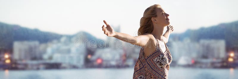 Woman with Arms Out Against Blurry Skyline Stock Photo - Image of ...