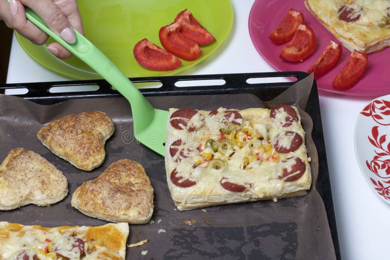 The Woman Arranges the Cooked Pizza from the Puff Pastry Over the ...