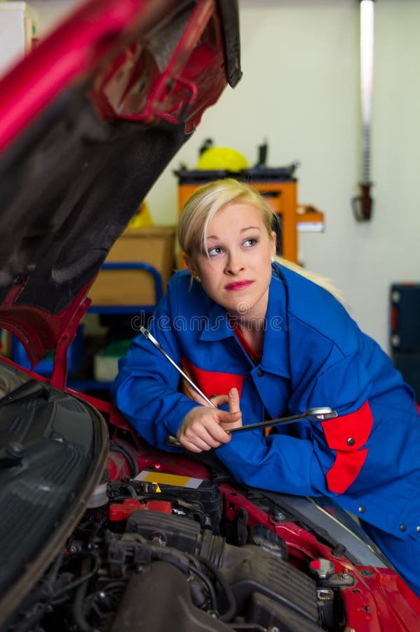 Female Car Mechanic Working on Jacked Auto Stock Photo - Image of ...