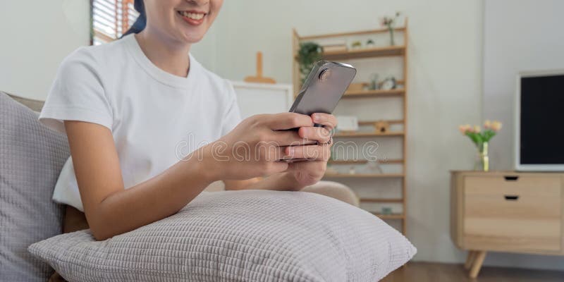 Woman Asian Check Social Network on Smartphone, Rest on Sofa. Weekend ...