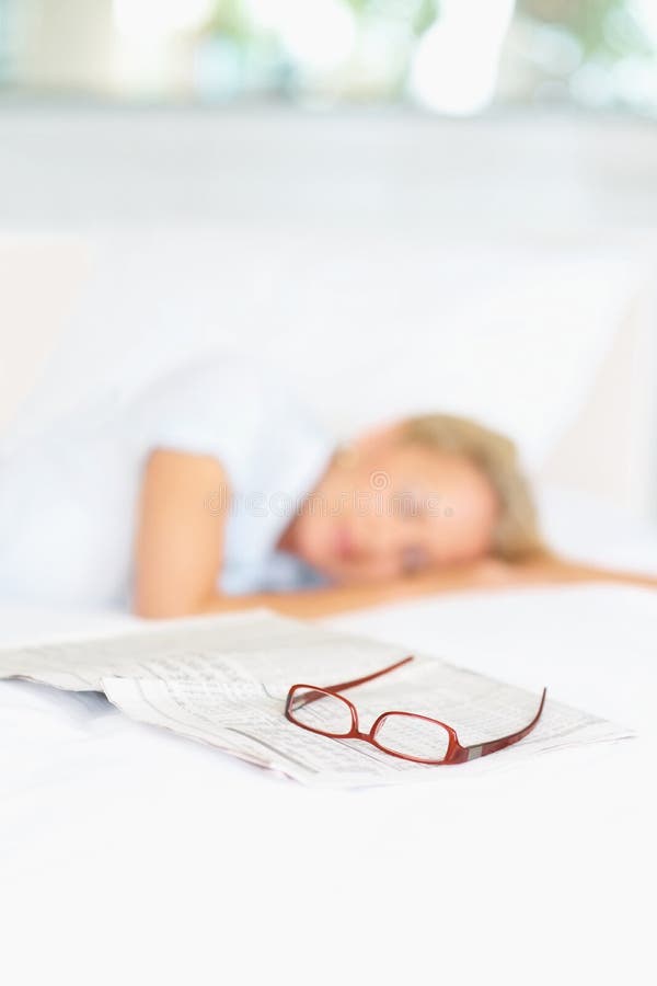 Woman Asleep after Reading Newspaper in Bed Stock Photo - Image of aged ...