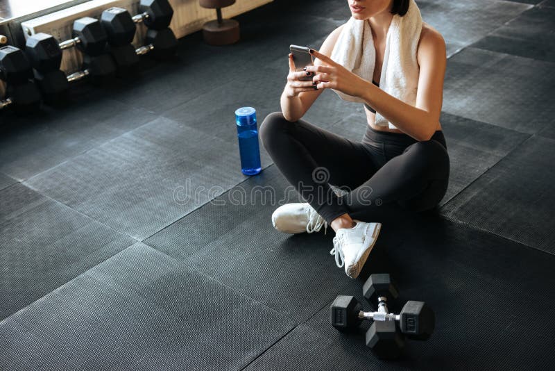 Woman Athlete Sitting and Using Mobile Phone in Gym Stock Photo - Image ...