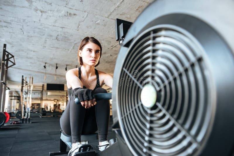 Woman Athlete Working Out with Training Machine in Gym Stock Photo ...