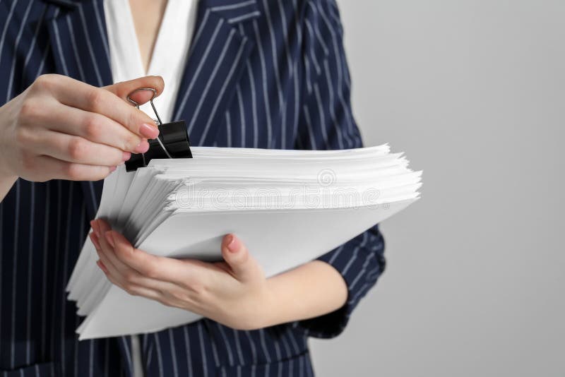 Woman Attaching Documents with Metal Binder Clip on Grey Background ...