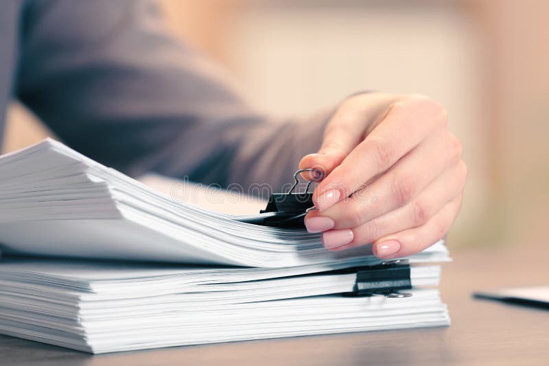 Woman Attaching Documents with Metal Binder Clip at Table in Office ...