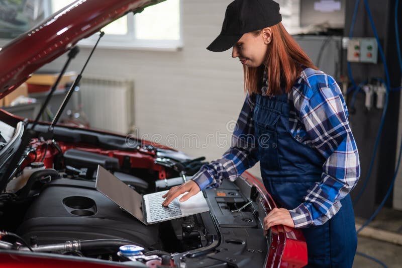 Woman Auto Mechanic Doing Engine Diagnostics Using Laptop. Stock Photo ...