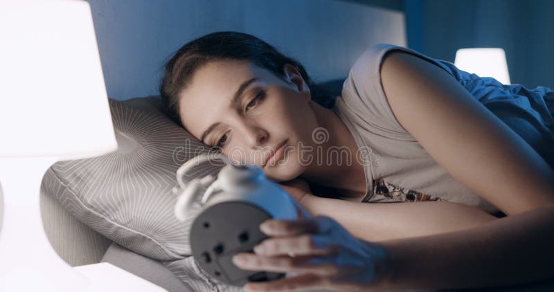 Woman Awake in Bed Checking the Time Stock Photo - Image of ...