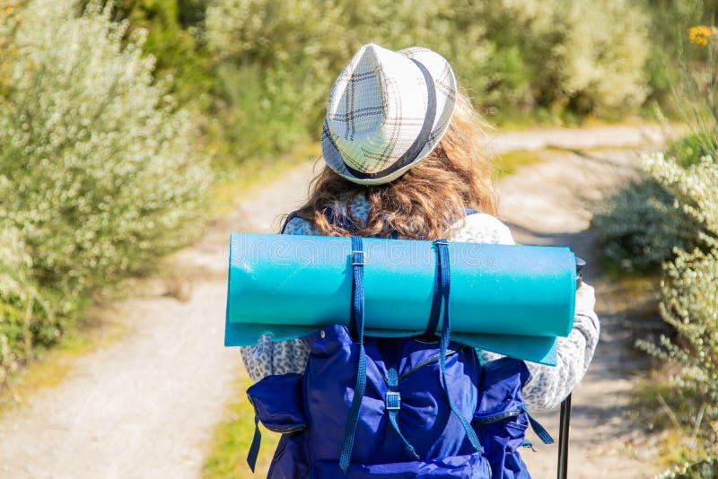Woman with backpack hiking stock photo. Image of route - 218559240