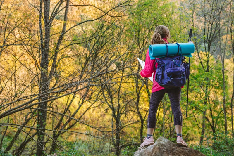 Woman with backpack hiking stock image. Image of compostela - 215775335