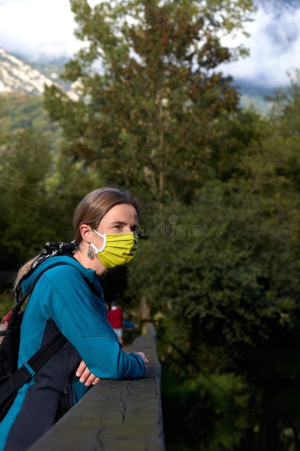 Woman with Backpack and Mask on a Wooden Bridge Stock Image - Image of ...