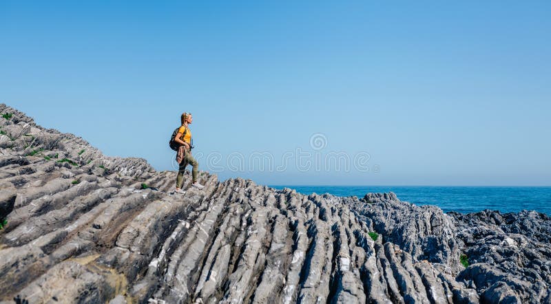 Woman with Backpack Walking through Flysch Rock Landscape Stock Photo ...