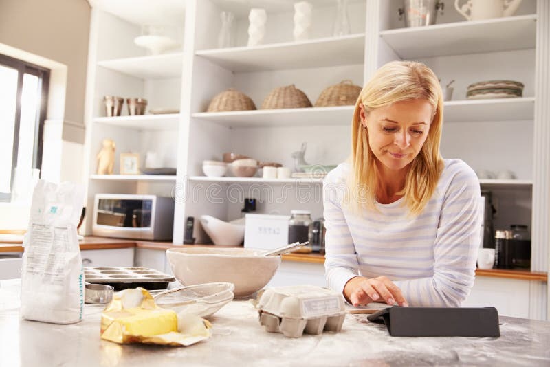 Woman Baking at Home Following Recipe on a Tablet Stock Photo - Image ...