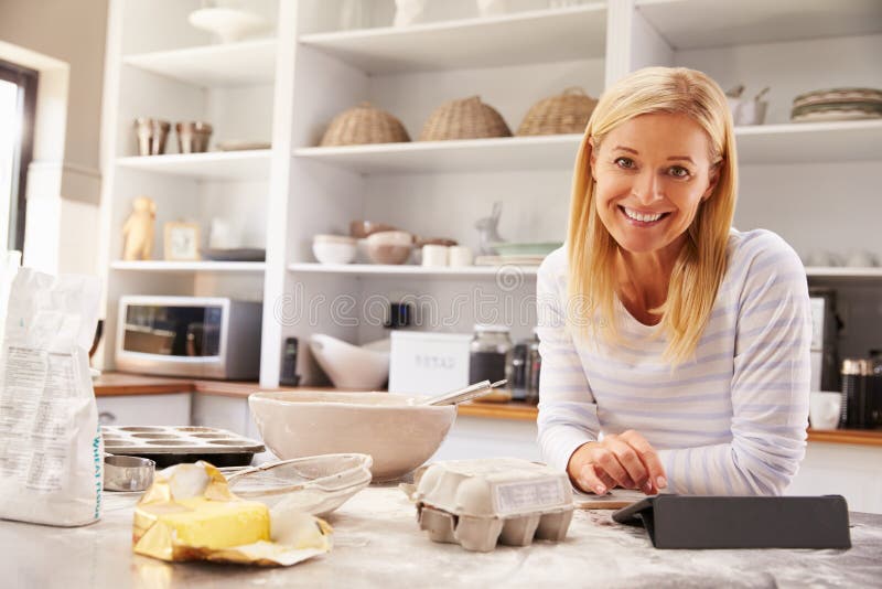 Woman Baking at Home Following Recipe on a Tablet Stock Photo - Image ...