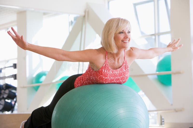 Woman Balancing on Swiss Ball Stock Image - Image of hair, fifties: 7231099