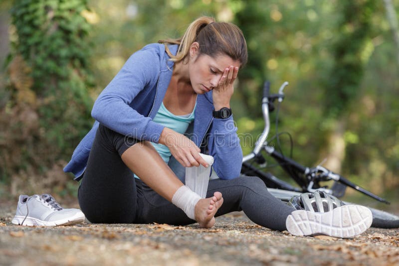 Woman bandaging ankle stock photo. Image of white, broken - 263373690
