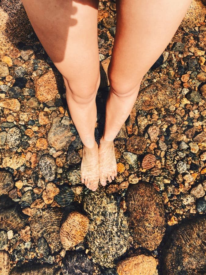 A Woman Barefoot Standing On The Stones Inside Pemigewasset River Stock