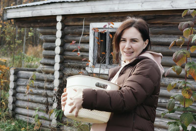 Woman with Basket Standing by the Log House Stock Photo - Image of ...