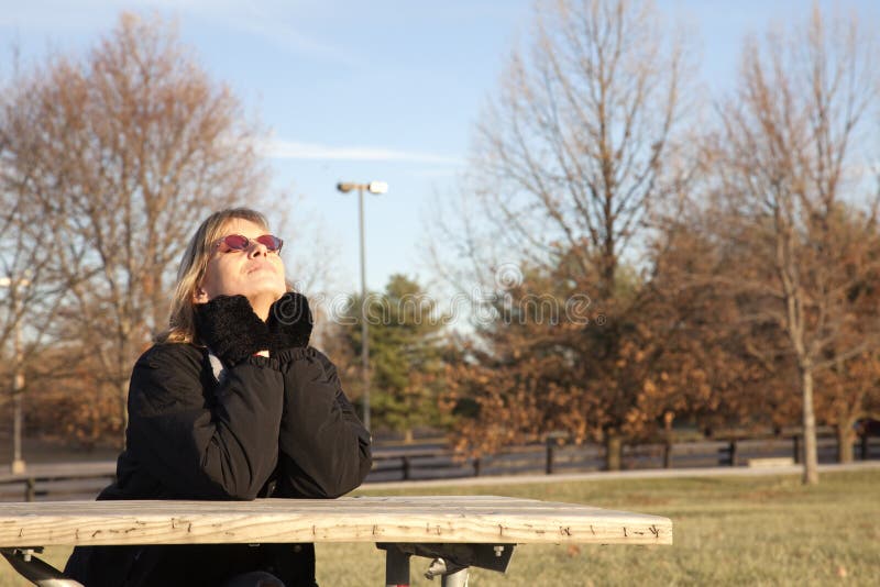 Woman Basking in Winter Sun Stock Photo - Image of happy, bench: 7592518