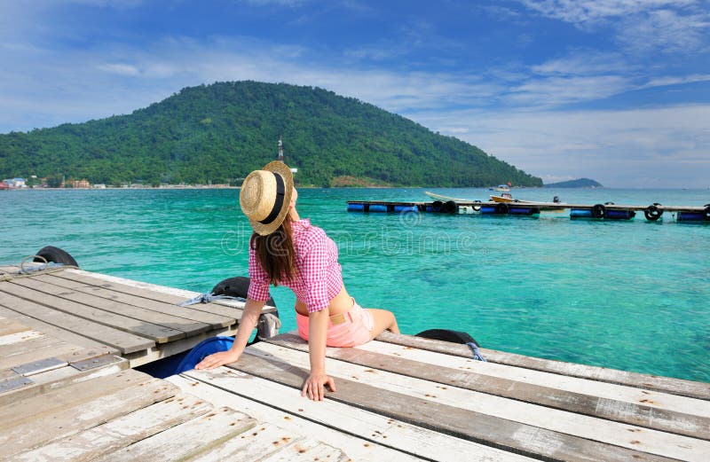 Woman at beach jetty stock photo. Image of tropical, destinations ...