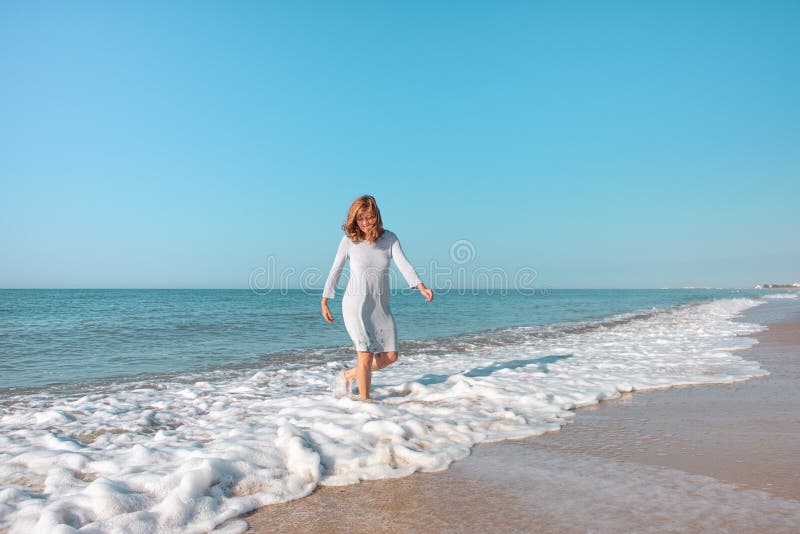Woman on the Beach Playing with the Waves Stock Image - Image of ...