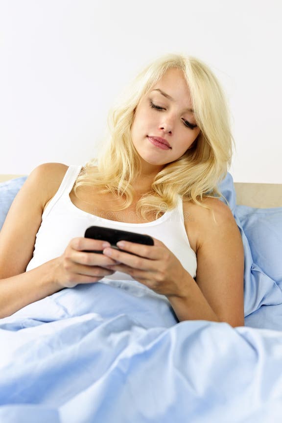 Woman in Bed with Cell Phone Texting Stock Image - Image of phone ...